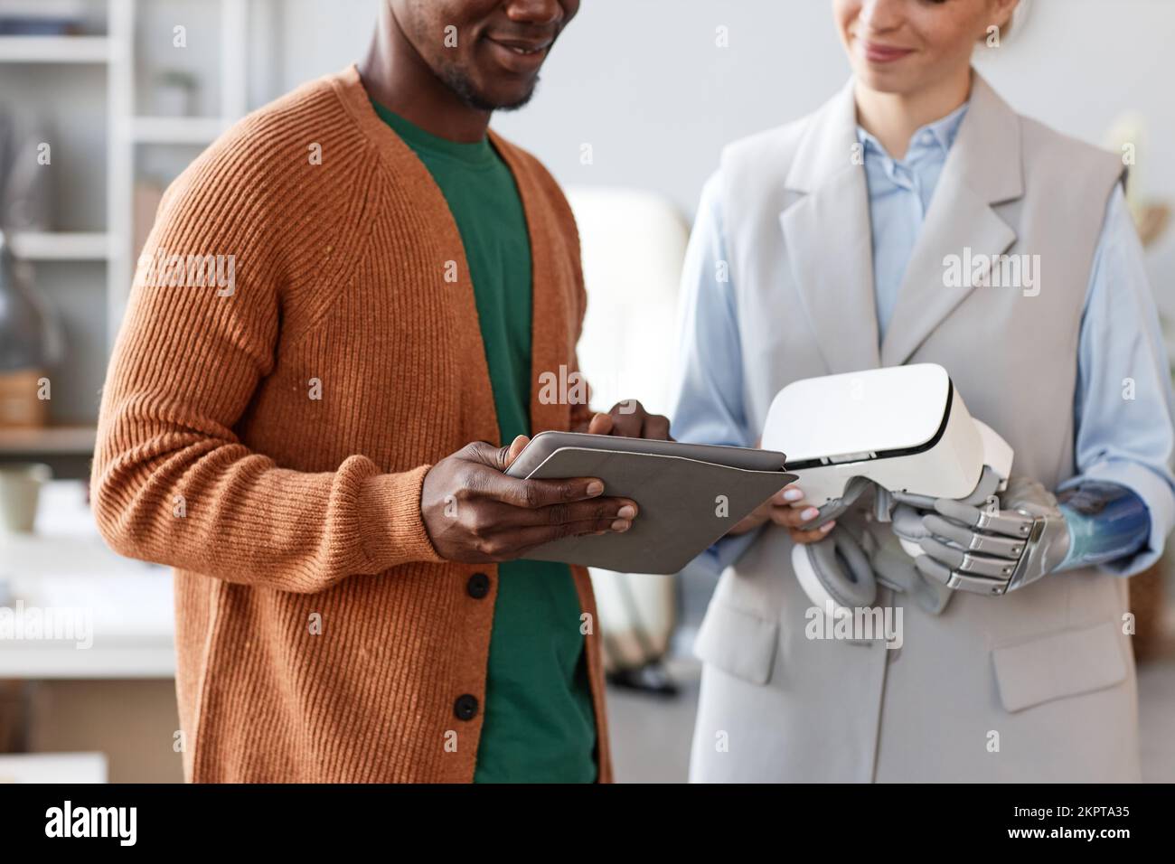 Positive software developer and his colleague testing new app they ...