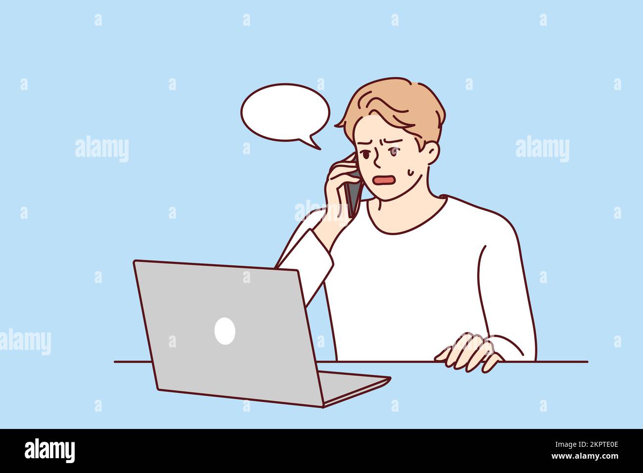 Angry young man sit at desk work on computer talk on cell about problem ...