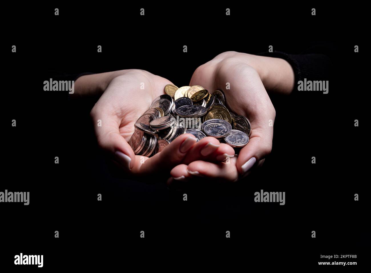 hands holding coins selective and soft focus isolated on black ...