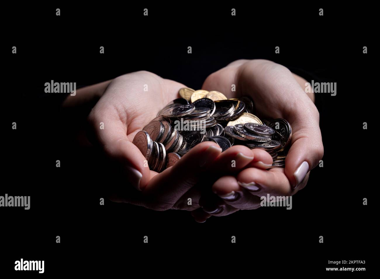 hands holding coins selective and soft focus isolated on black ...