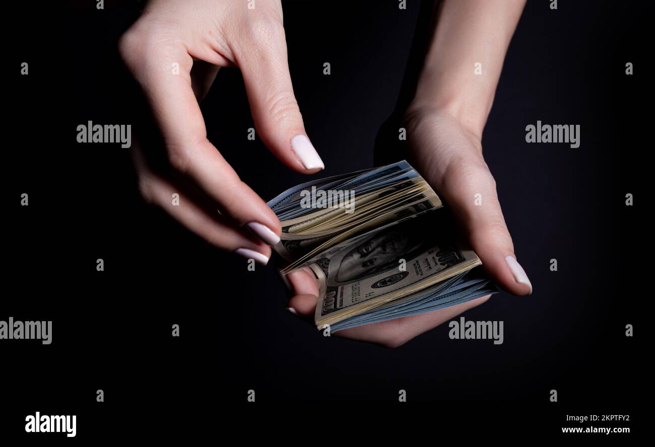 two hands with dollars. Closeup female hand giving money for something ...