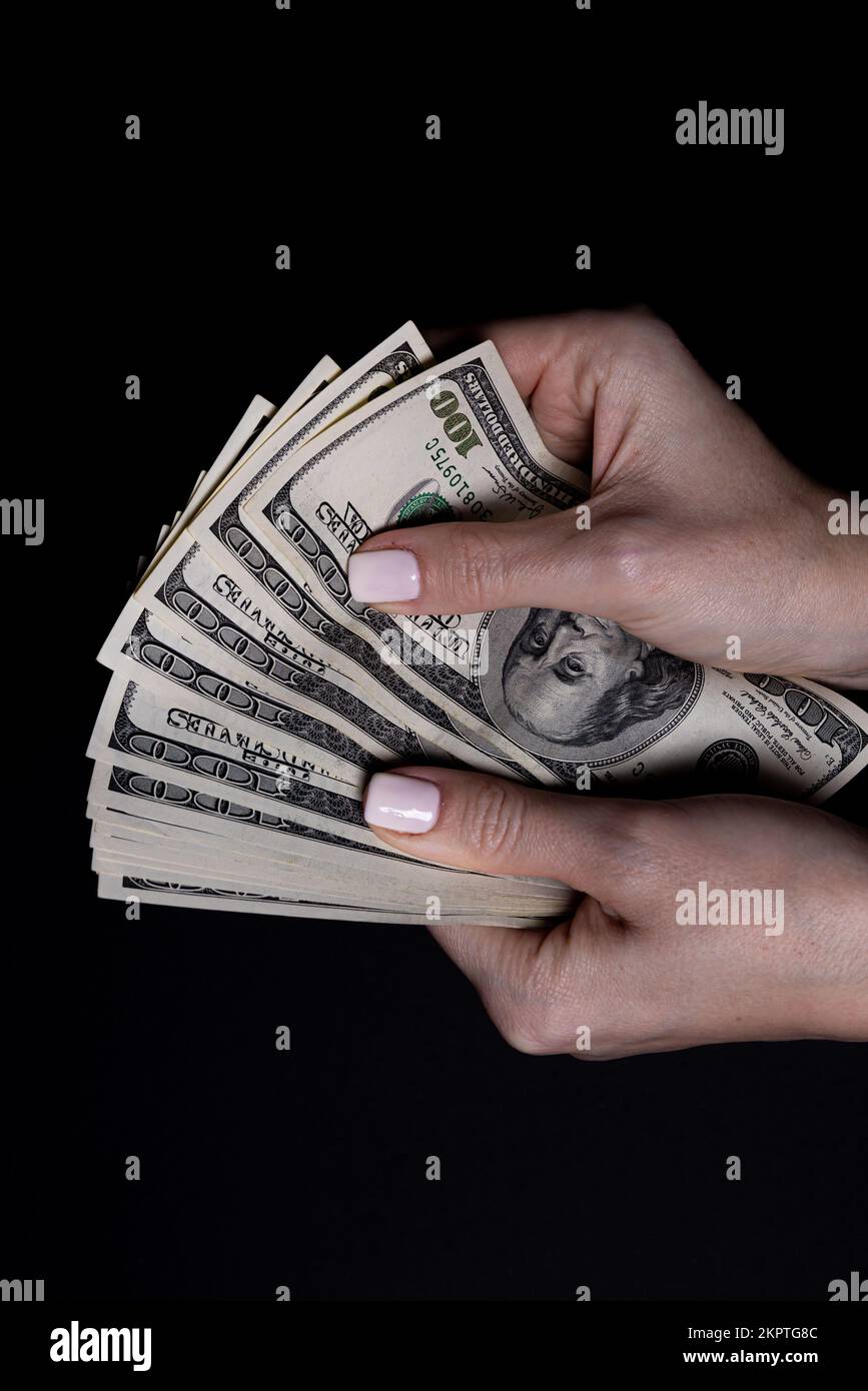 two hands with dollars. Closeup female hand giving money for something ...