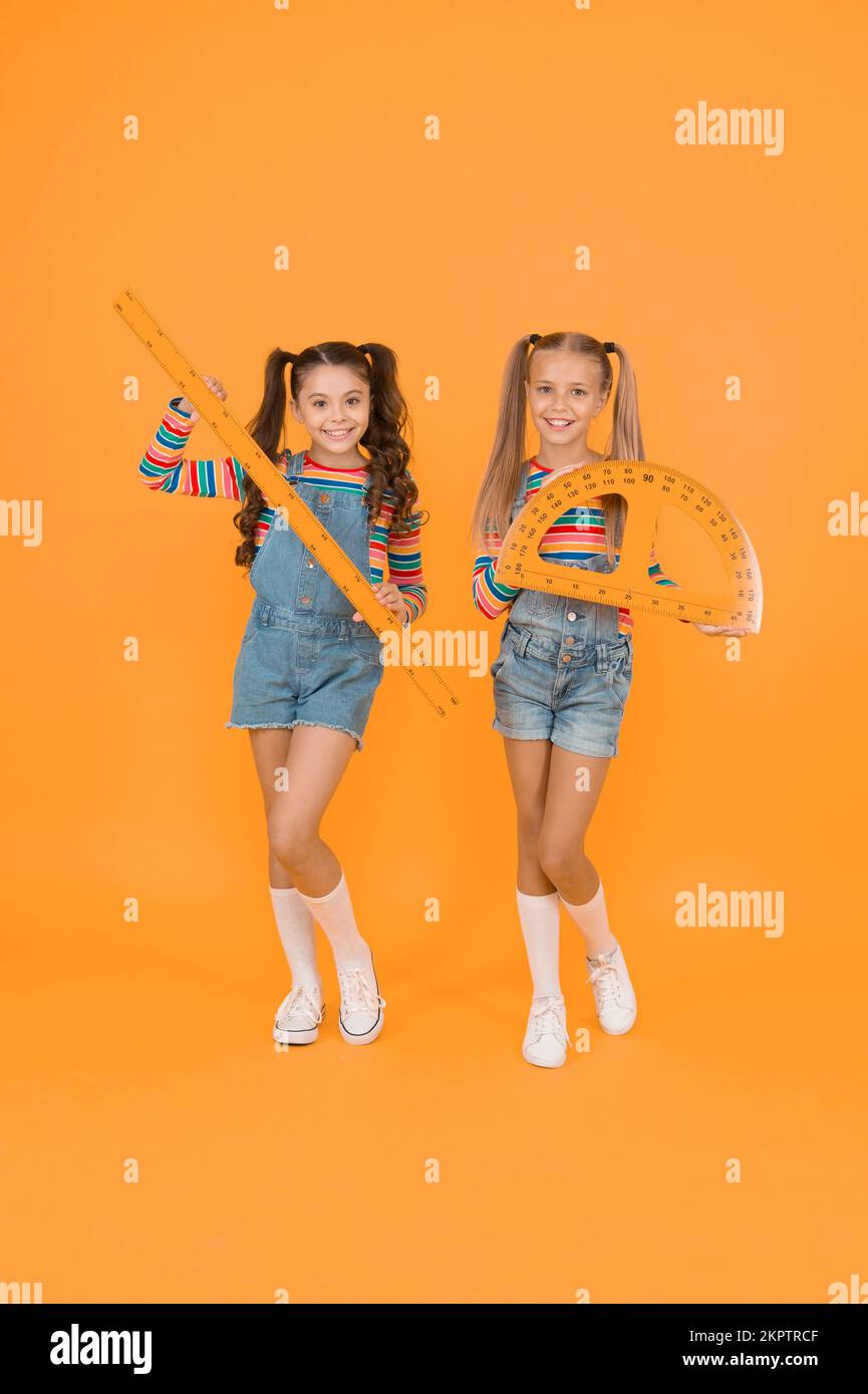 Geometry favorite subject. small girls hold ruler and protractor ...