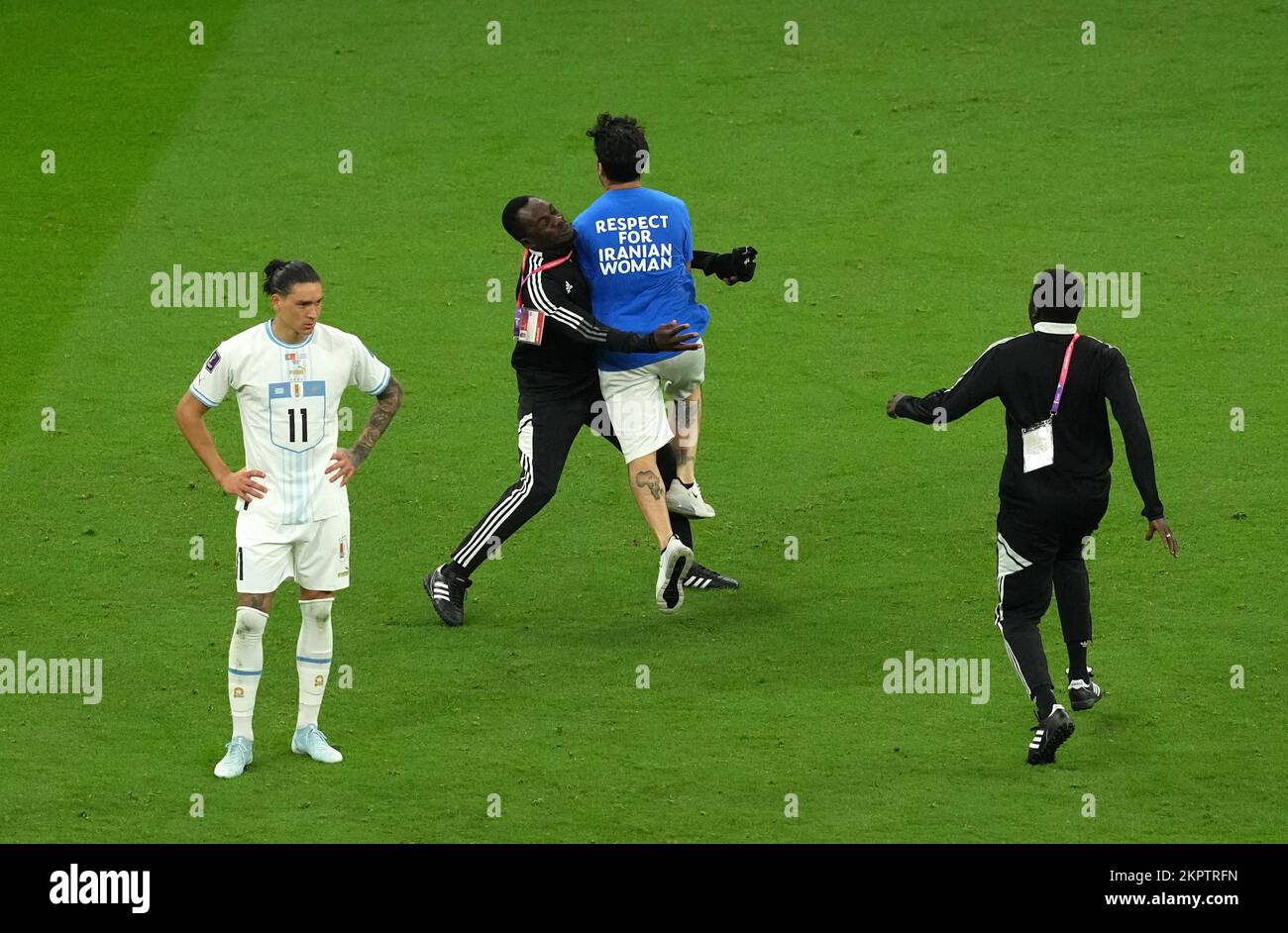 A protestor in a top reading "Respect For Iranian Women" tackled by a ...