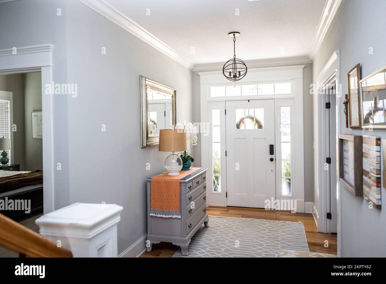 An open large and wide interior front door hallway foyer with transom ...