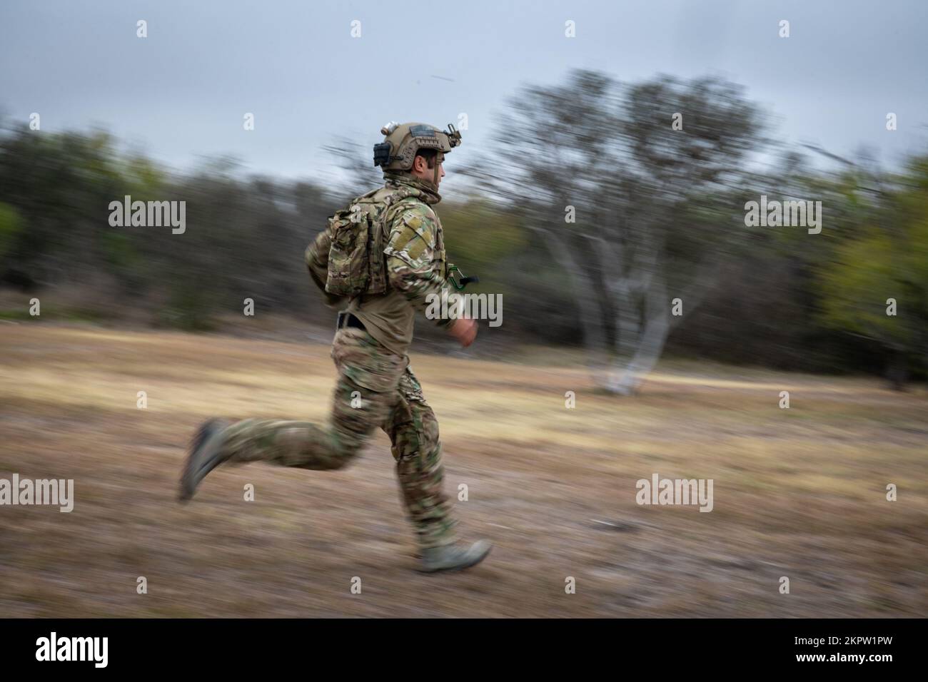 A Tactical Air Control Party Airman runs to a gun assembly station ...