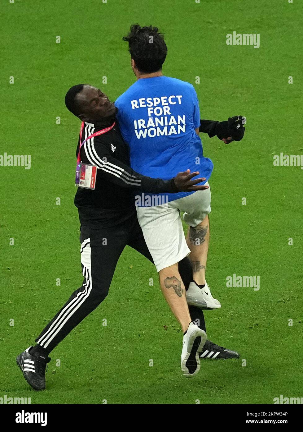 A protestor in a top reading "Respect For Iranian Women" tackled by a ...
