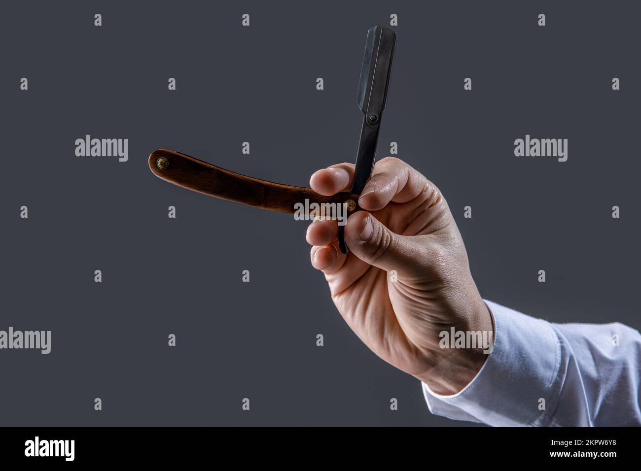 hand with barbershop razor blade. hand hold barbershop razor blade in ...