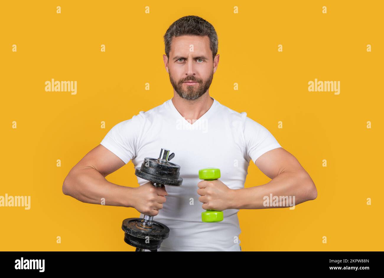 strong sport man exercise with dumbbell in shirt. strong sport man ...