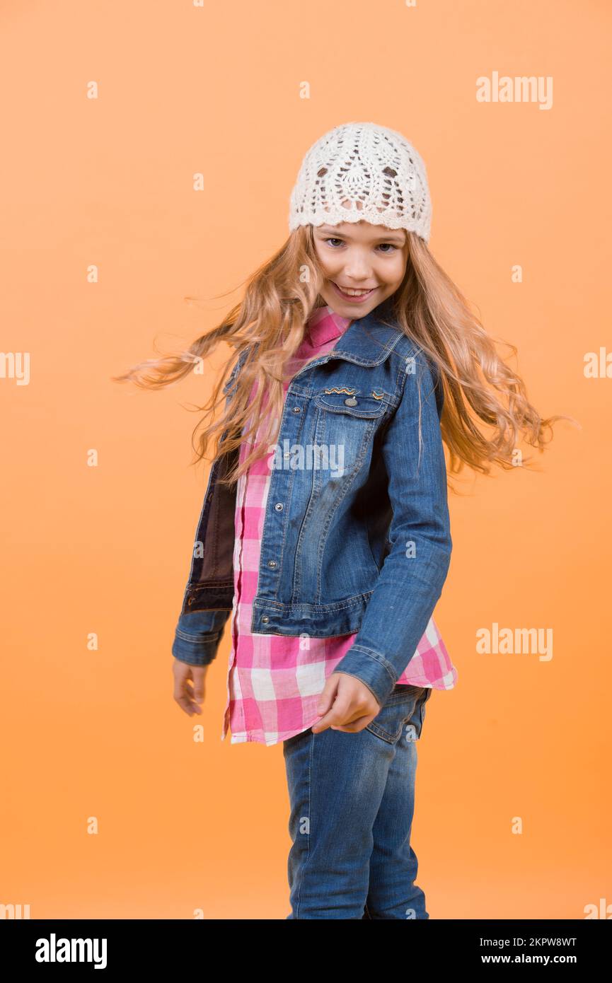 Girl in jeans suit, hat, plaid shirt on orange background Stock Photo ...