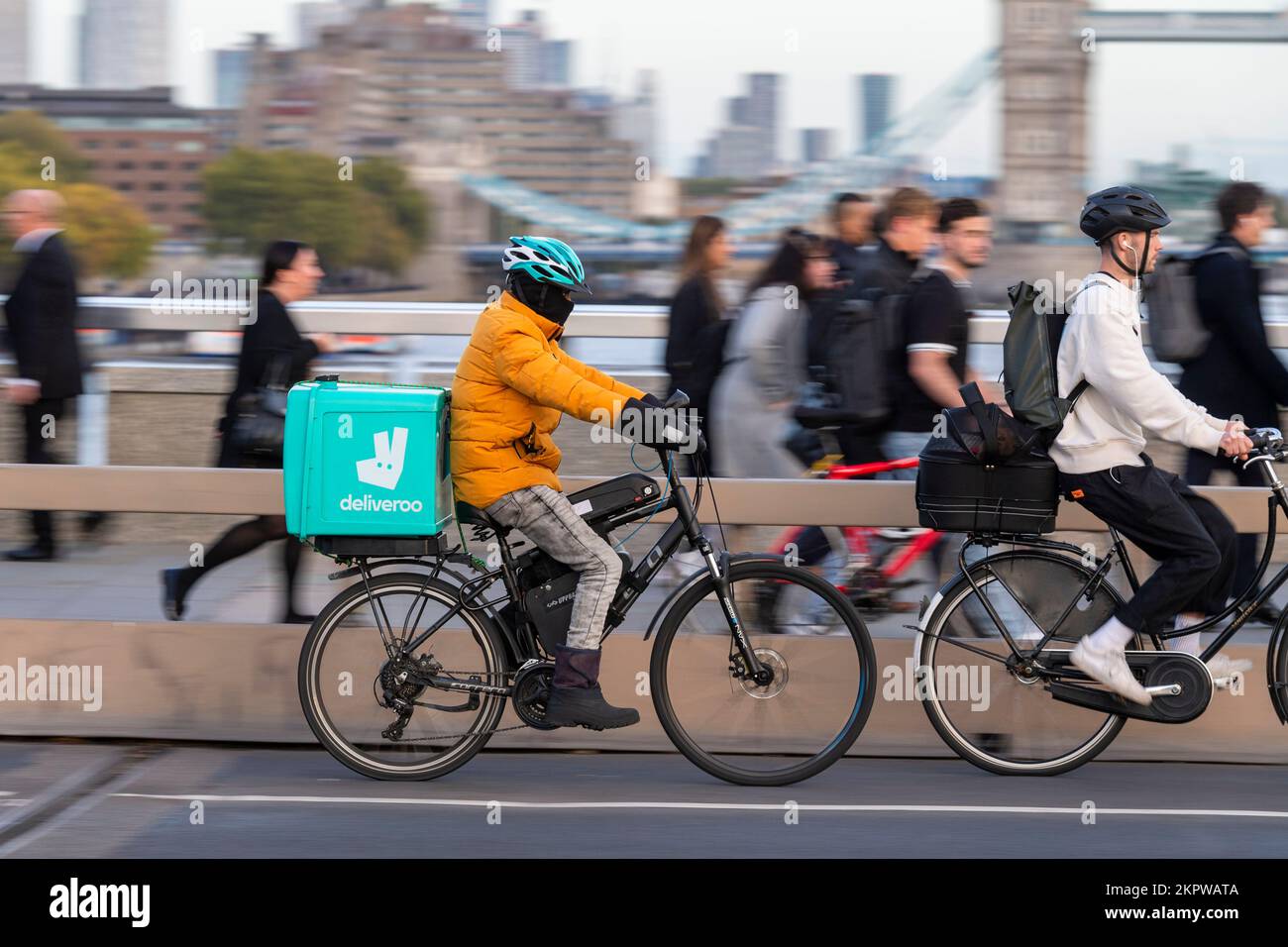 A deliveroo cycle courier riding an e-bike across, London Bridge, London, UK. 18 Oct 2022 Stock ...