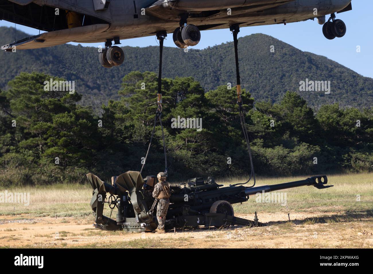 U.S. Marines with 3rd Battalion, 12th Marines attach an M777 Howitzer ...