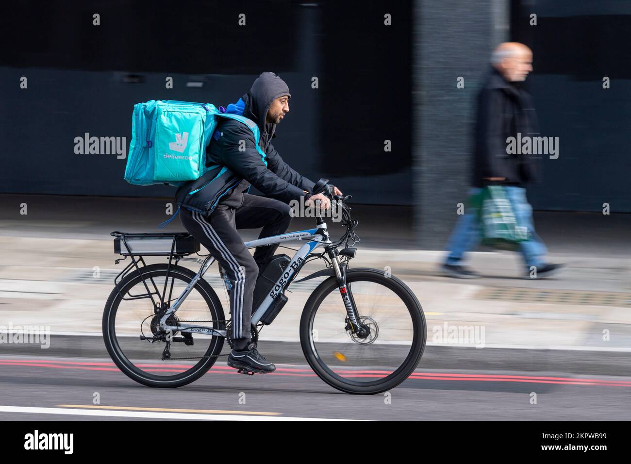 A Deliveroo cycle courier riding an e-bike, York Road, London, UK. 16 Oct 2022 Stock Photo - Alamy