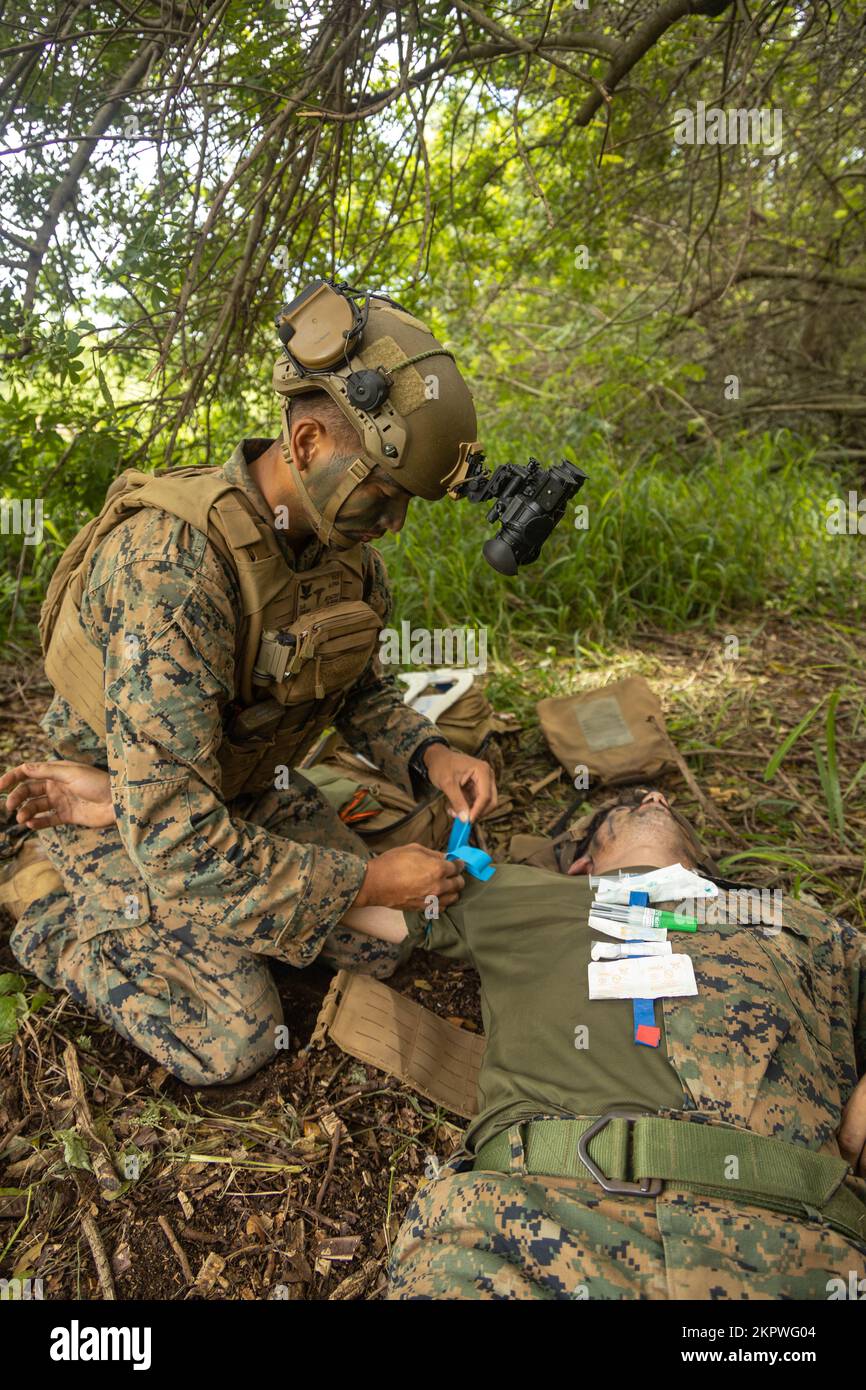 U.S. Navy Petty Officer 3rd Class Damienandr, hospital corpsman, left ...