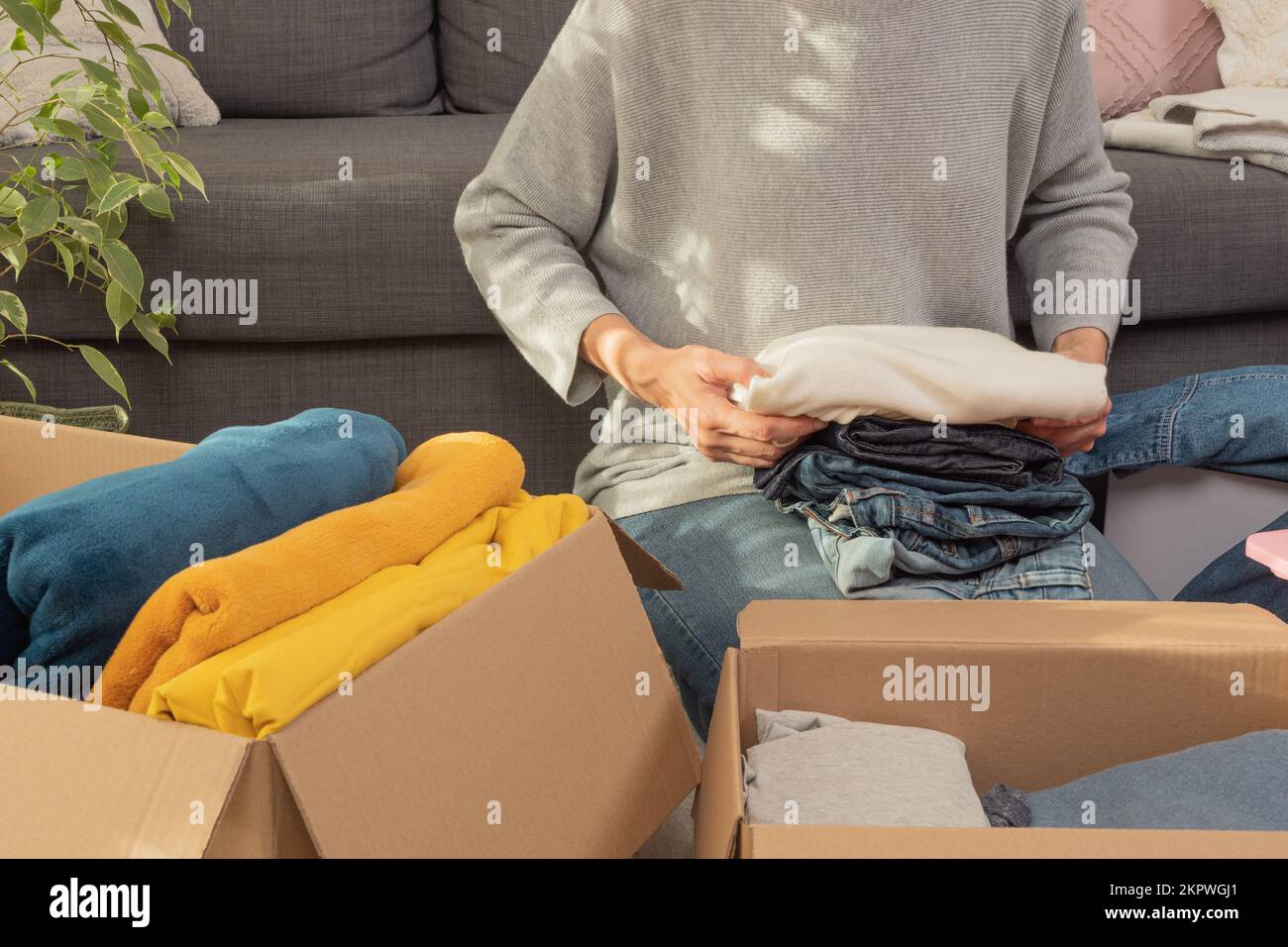 Woman sorting clothes home hi-res stock photography and images - Alamy
