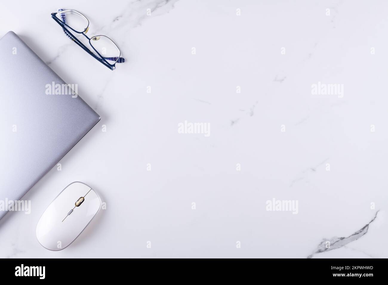 Business concept frame with a laptop on the white marble background ...