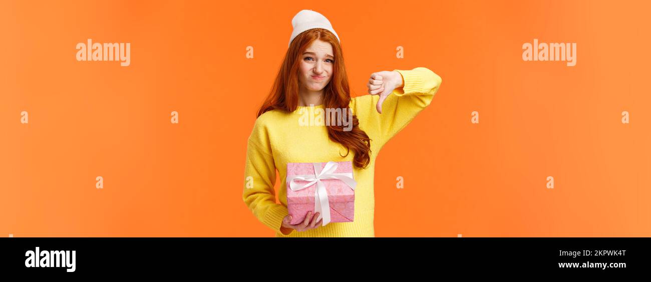 Skeptical and awkward cute redhead picky girl dont like christmas gift ...