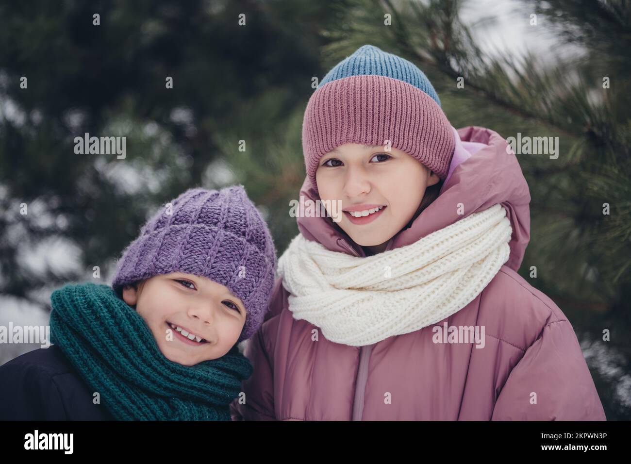 Photo of charming positive little children dressed coat enjoying snowy ...