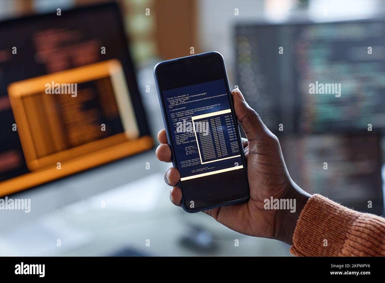 Hand of developer showing programming code on smartphone screen Stock ...