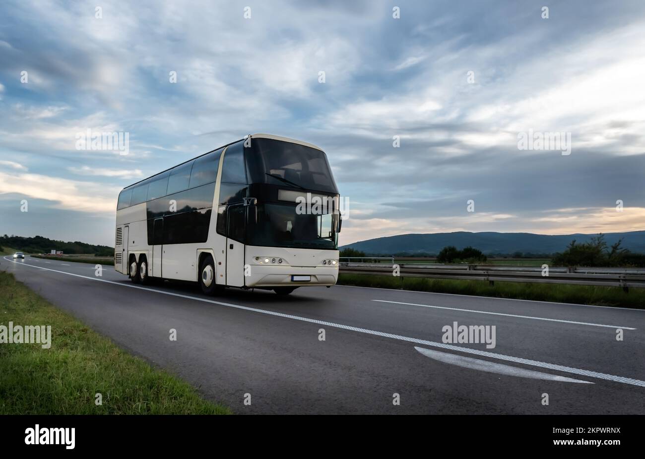 White Bus on the country highway road road Stock Photo - Alamy