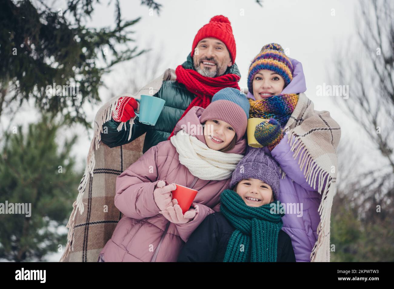 Photo of full peaceful cheerful family shoulders covered blanket hold ...