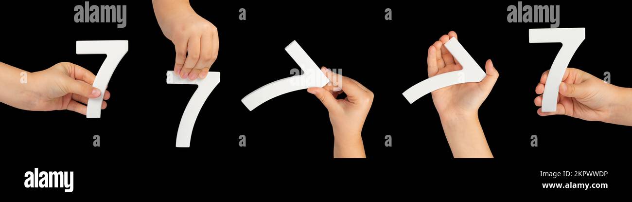 Number seven in hand isolated on black background. Number 7 in a child ...