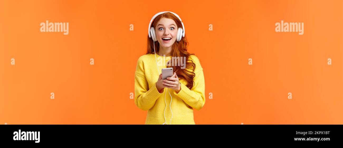 Surprised and astonished, excited smiling redhead girl found out ...