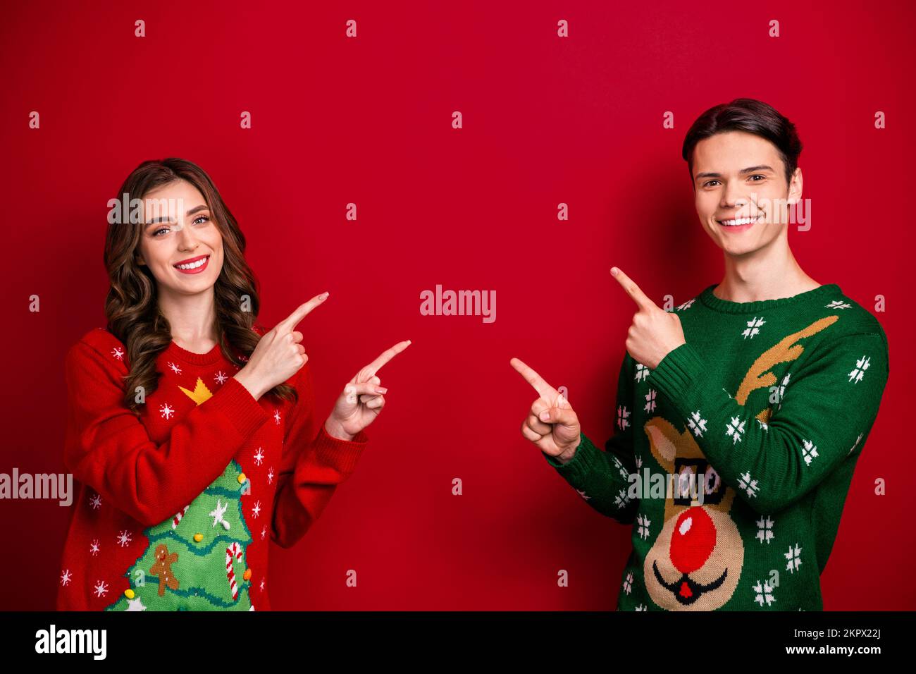 Photo of sweet charming best friends dressed x-mas jumpers pointing ...