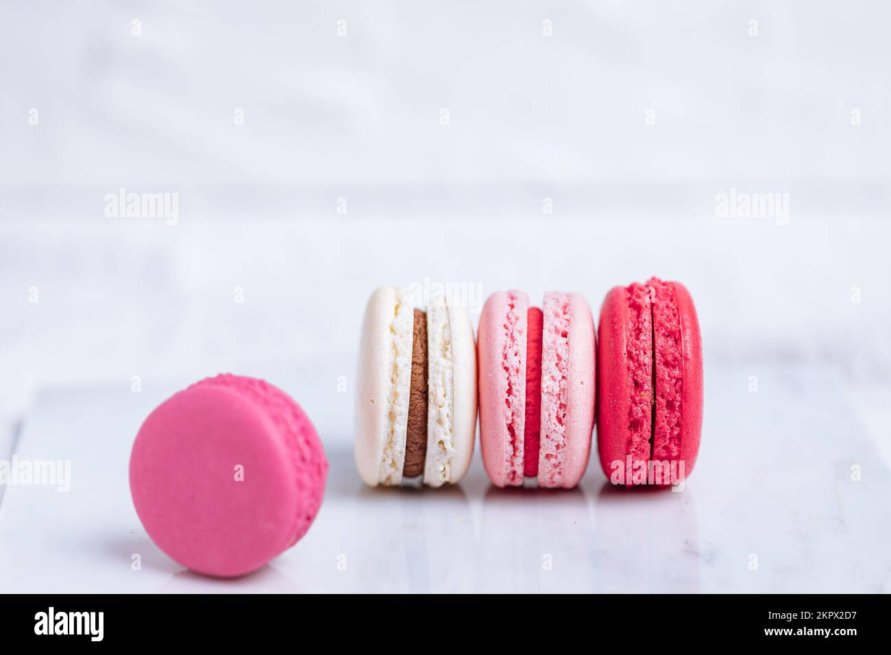 Close up of Macaroons in different colours on bright white background ...