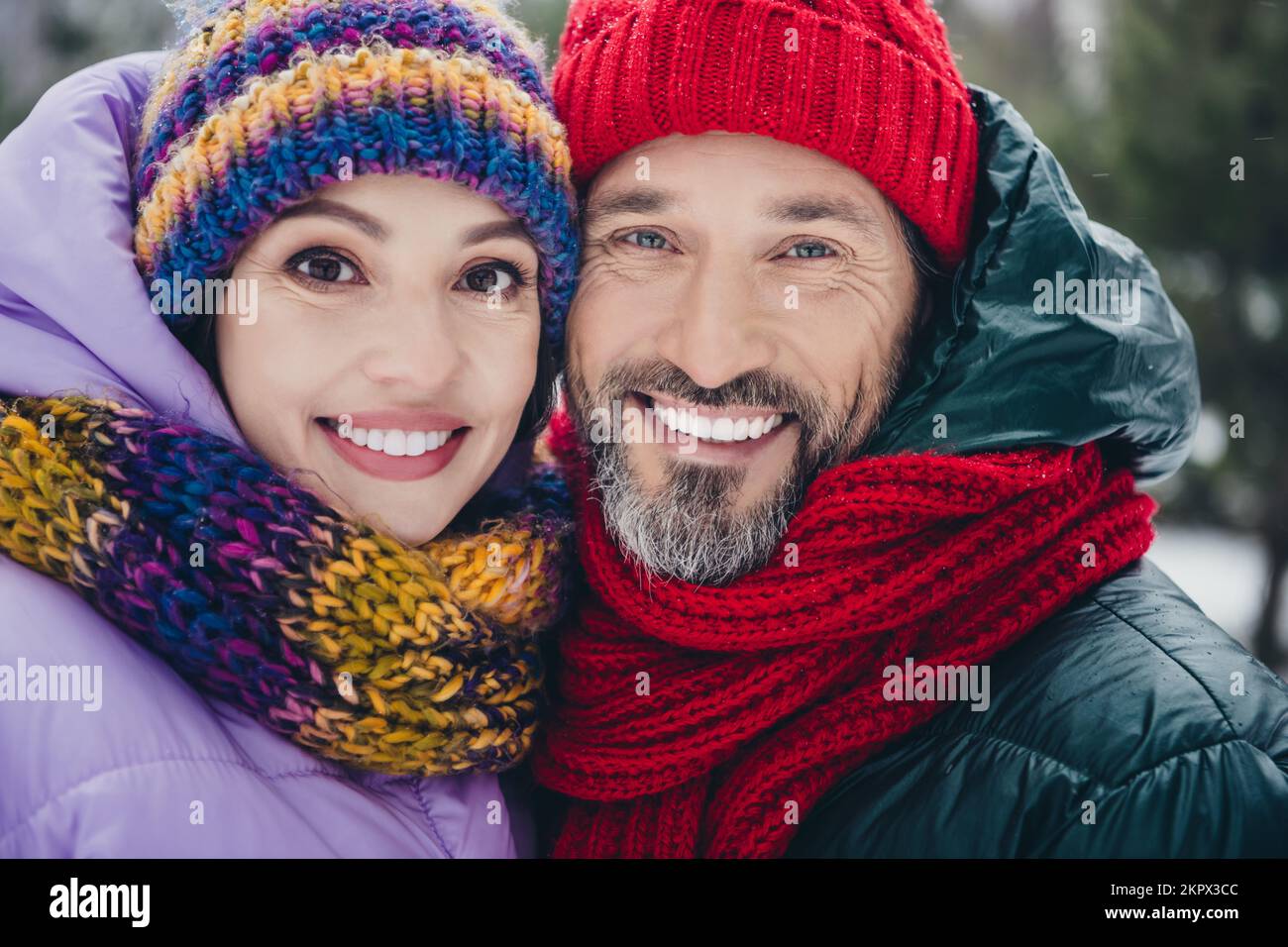 Photo of good mood pretty wife husband dressed coats embracing smiling ...