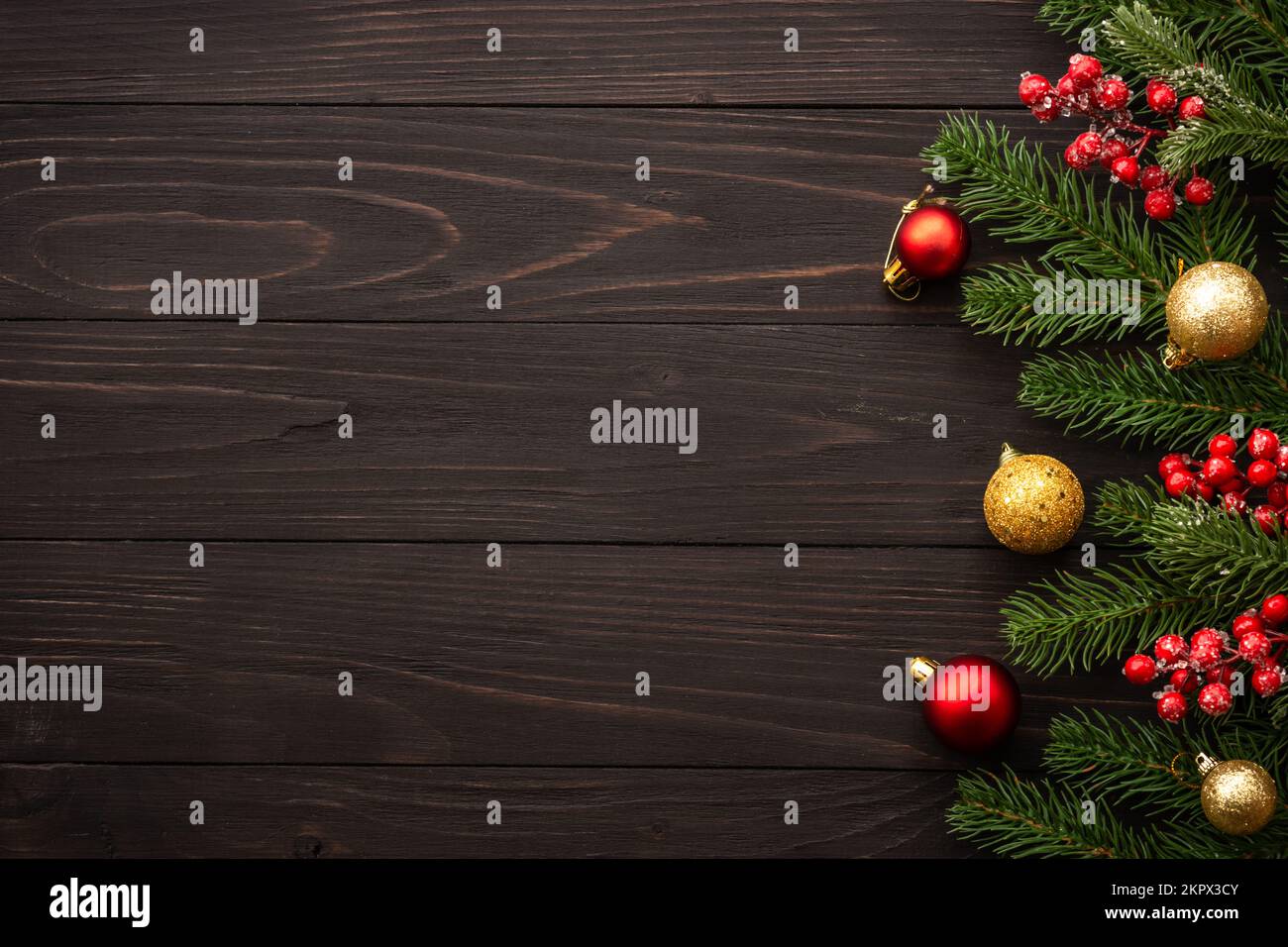 Christmas background on wooden. Fir tree brunch and red decorations ...