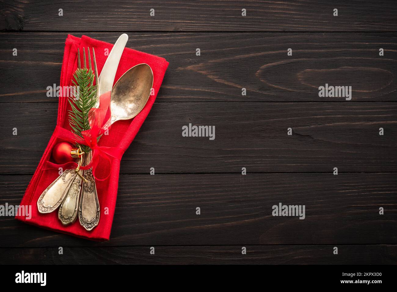Christmas table setting with plate, cutlery and christmas decorations ...