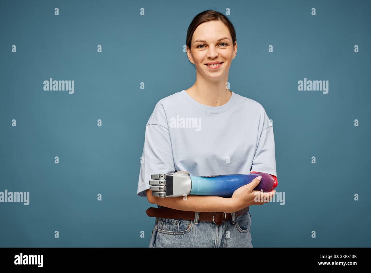 Studio portrait of positive young woman with bionic arm Stock Photo - Alamy