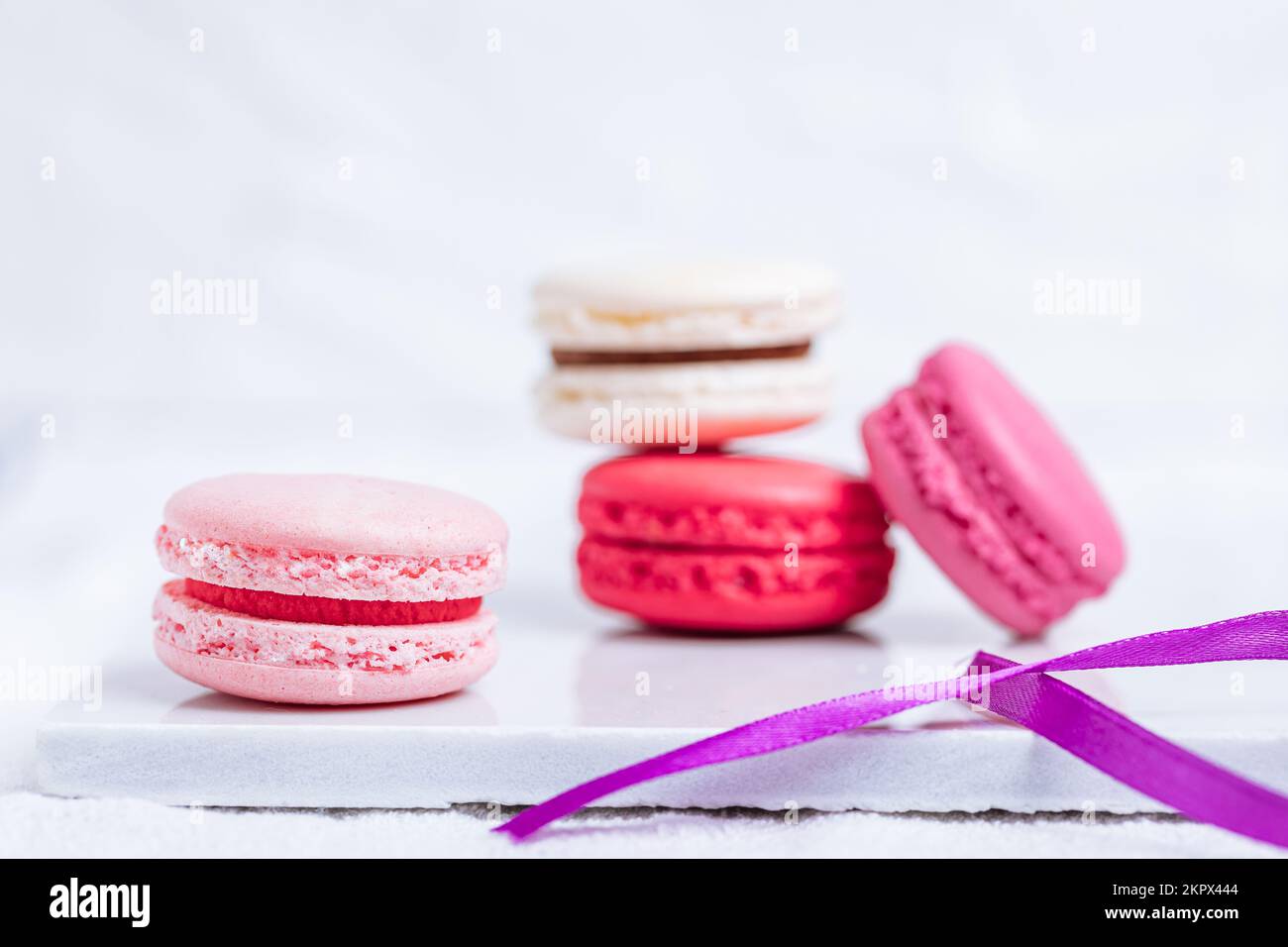 Close up of Macaroons in different colours on bright white background ...