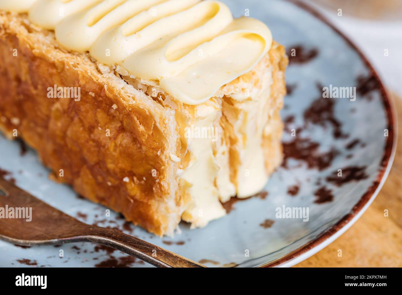 French dessert called Mille Feuille or Napoleon cake on rustic wooden ...
