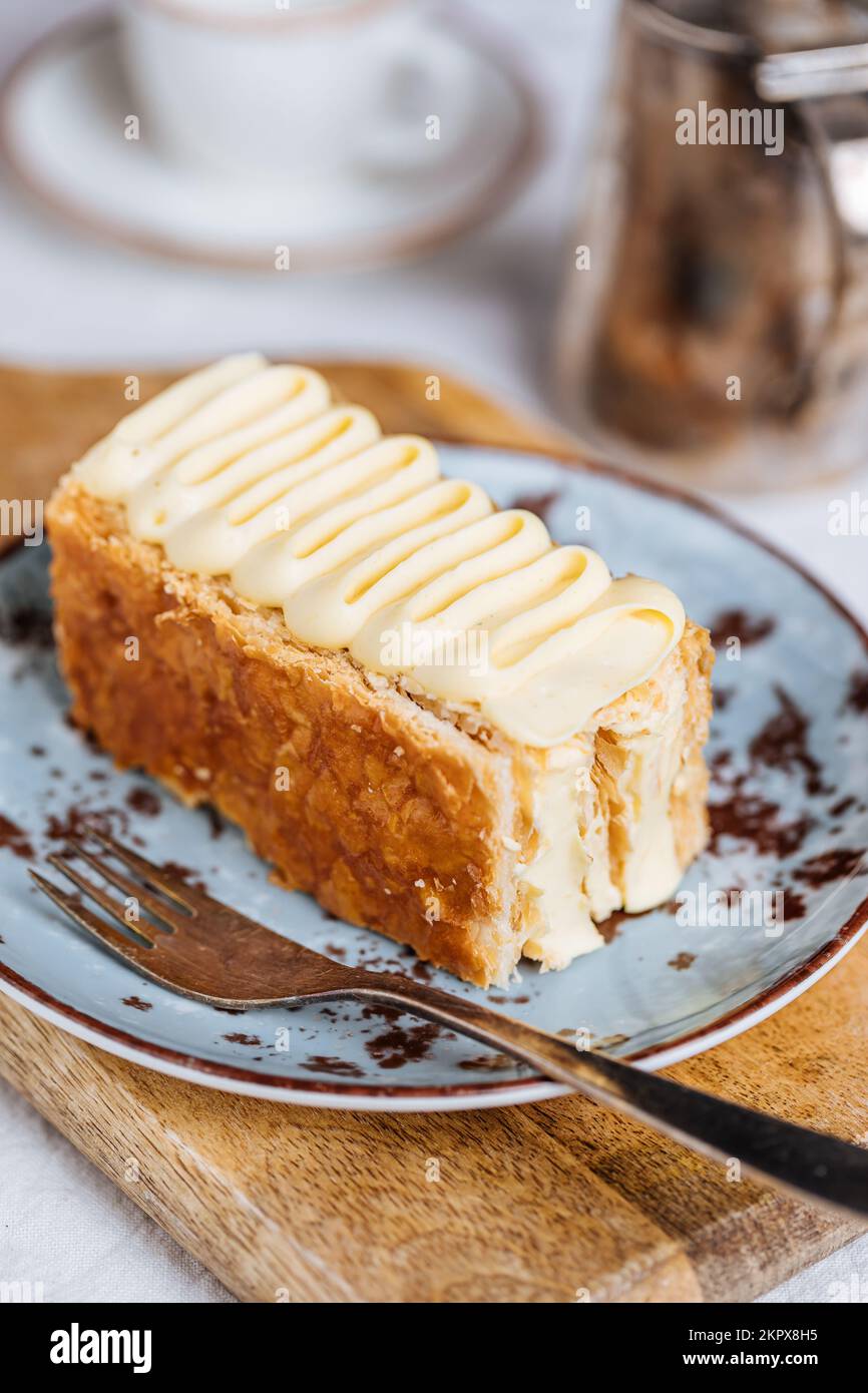 French dessert called Mille Feuille or Napoleon cake on rustic wooden ...