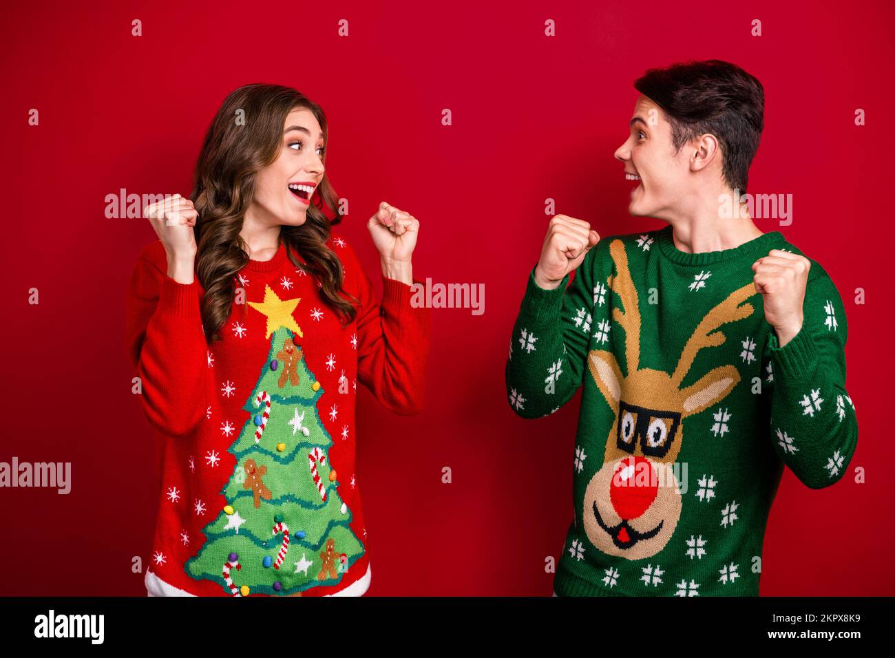 Photo of cute impressed best friends dressed x-mas jumpers screaming ...