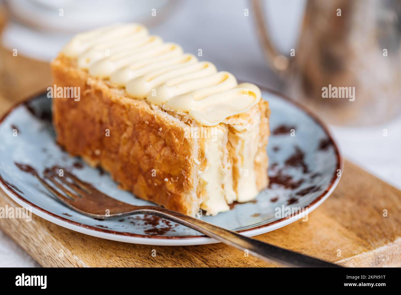 French dessert called Mille Feuille or Napoleon cake on rustic wooden ...