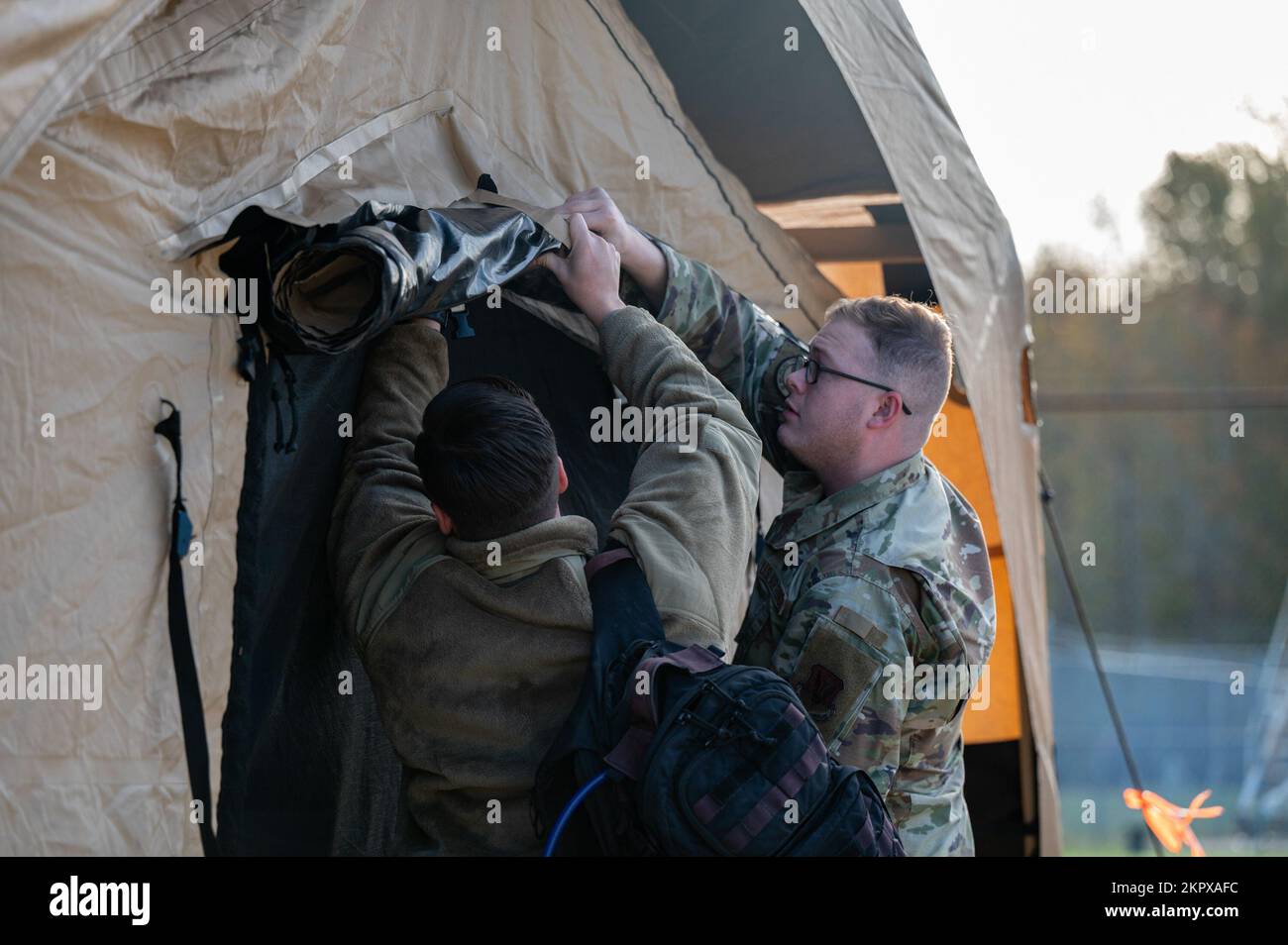 U.S. Air Force Airmen make their way inside a tent that is set up as a ...