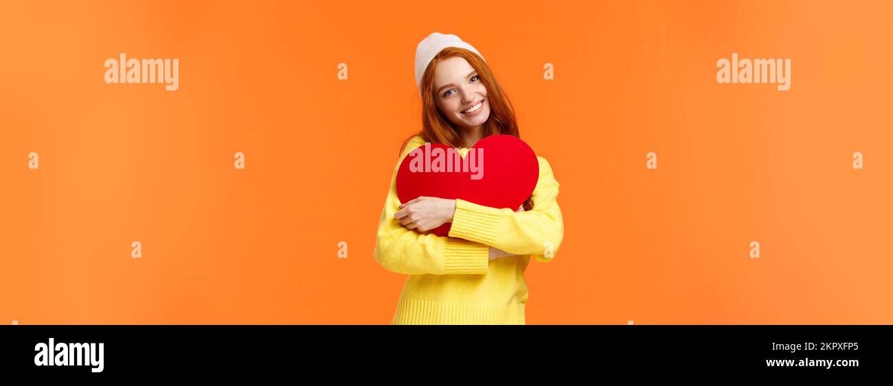 Tender and romantic dreamy redhead woman in winter hat, sweater ...
