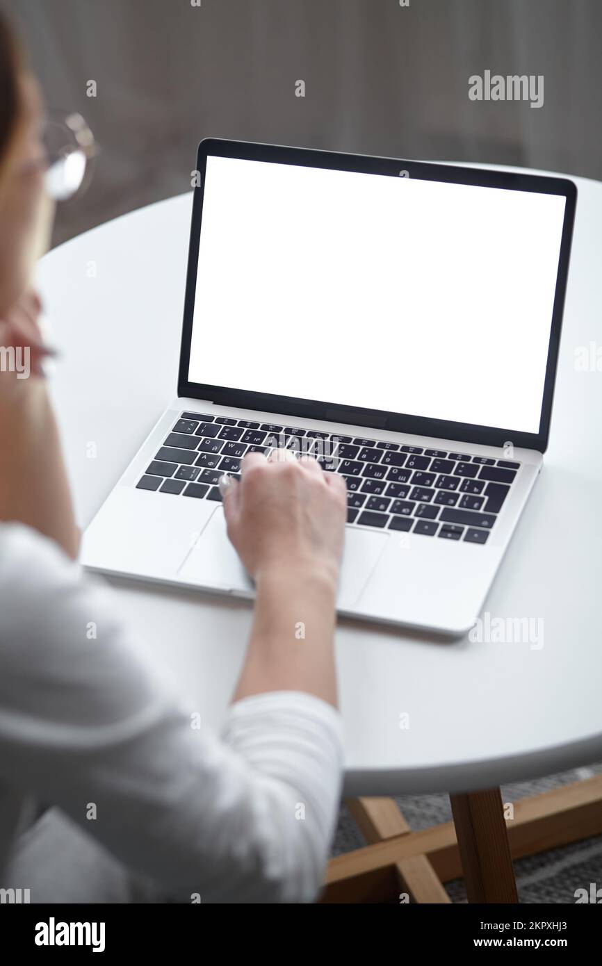 Mockup white screen laptop woman using computer while sitting at table ...