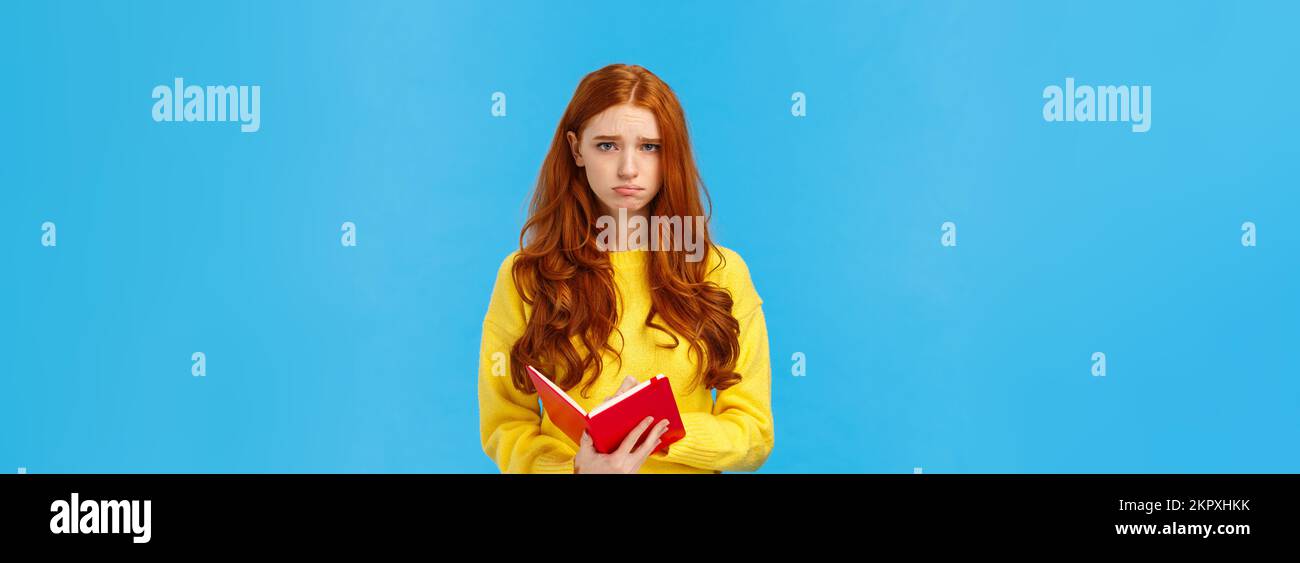 Upset and uneasy, sad cute redhead girl in yellow sweater, sulking ...