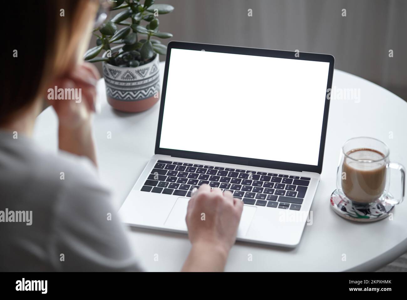 Mockup white screen laptop woman using computer while sitting at table ...