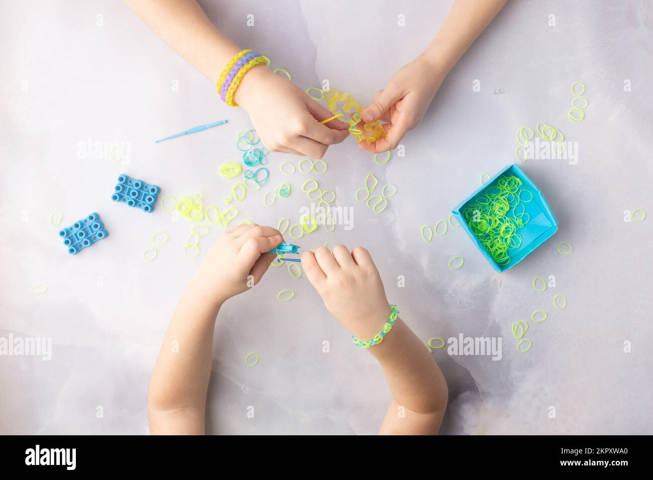 Concept of making loom bracelets by kids blue and yellow Stock Photo ...