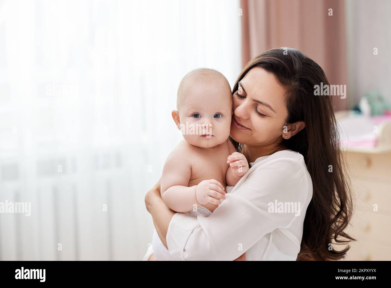 Happy mother holding and hugging adorable newborn baby Stock Photo - Alamy