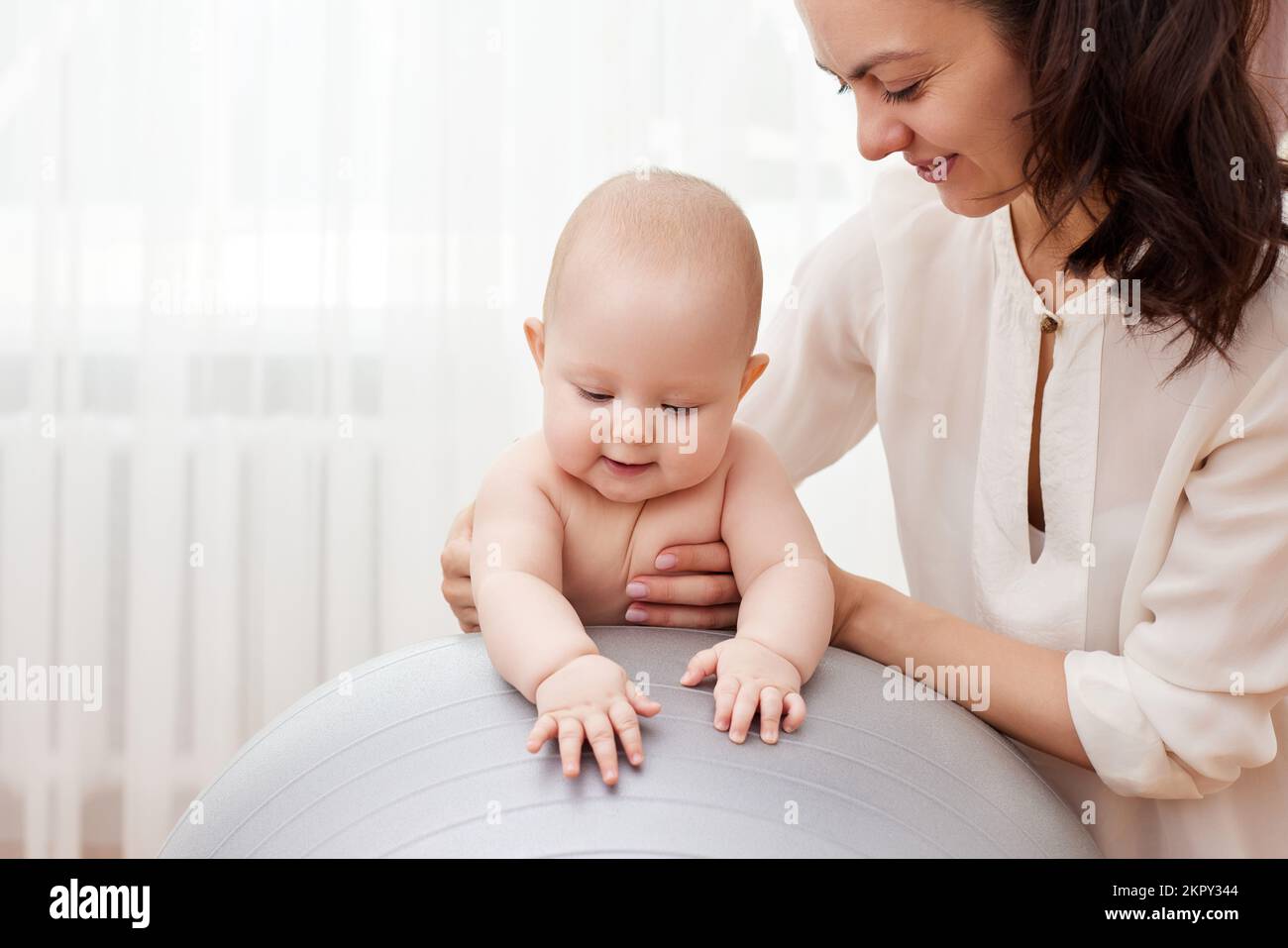 Playing baby on fit ball hi-res stock photography and images - Alamy
