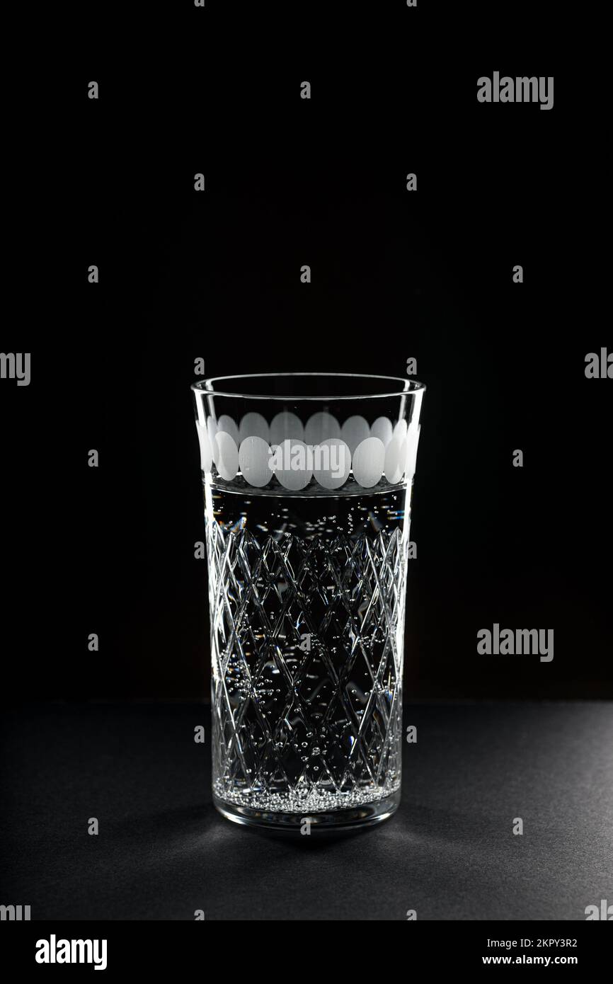 Glass of drink water with gas on black background Stock Photo - Alamy