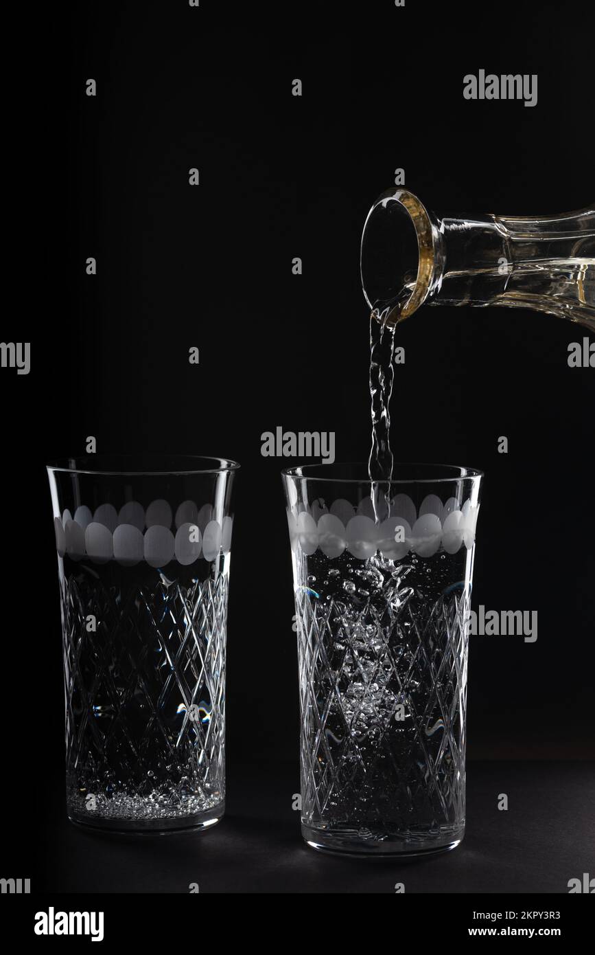 Glass of drink water with gas on black background Stock Photo - Alamy