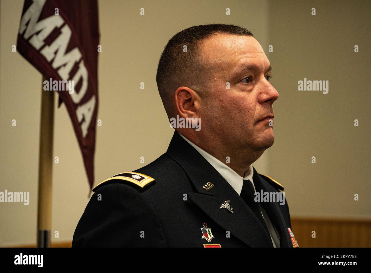 U.S. Army Lt. Col. Robert Brutcher stands at attention during the ...