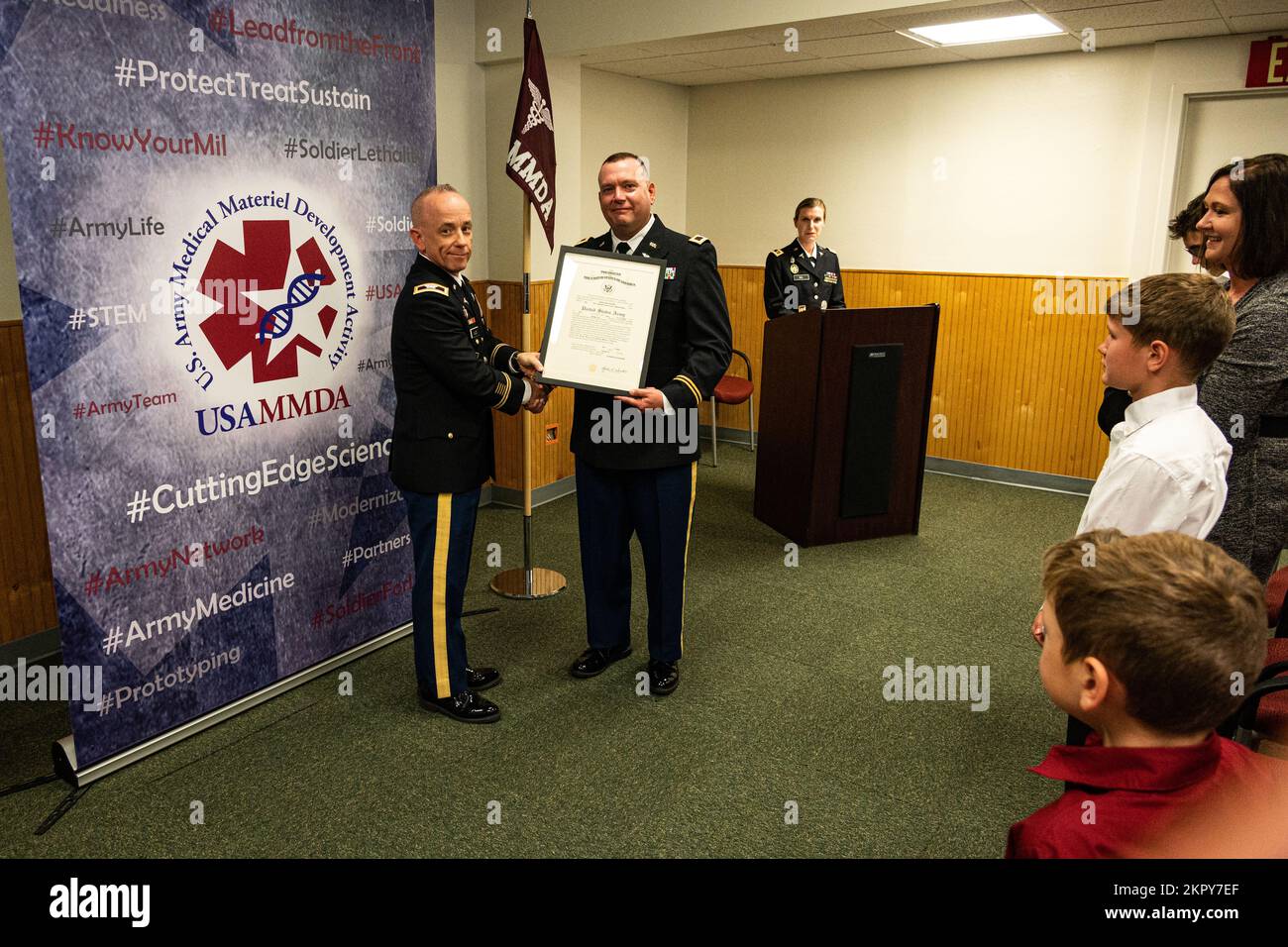 U.S. Army Col. Andy Nuce presents a promotion warrant to newly promoted ...